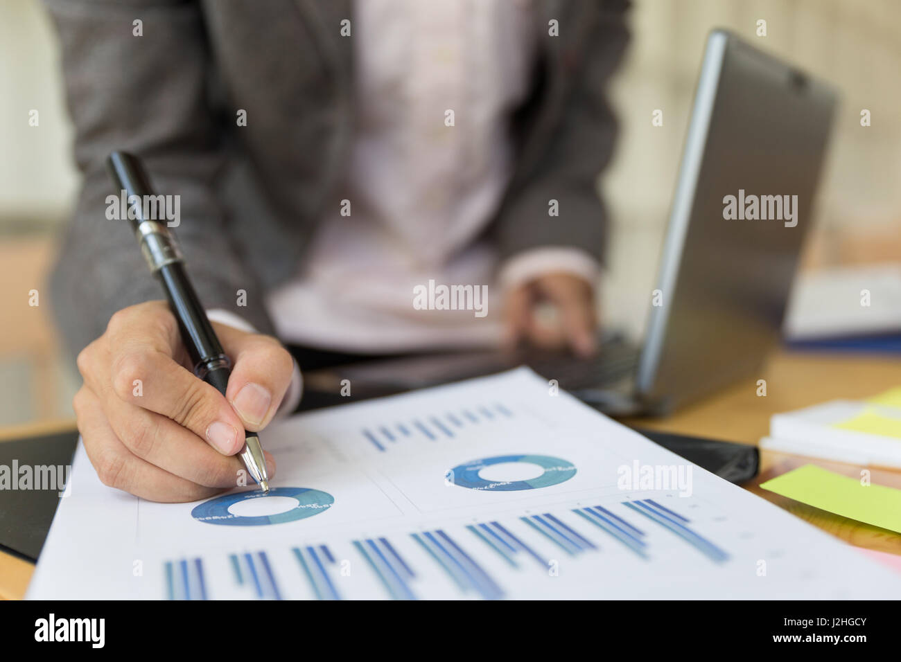 Business woman analyzing income charts and graphs with modern laptop ...