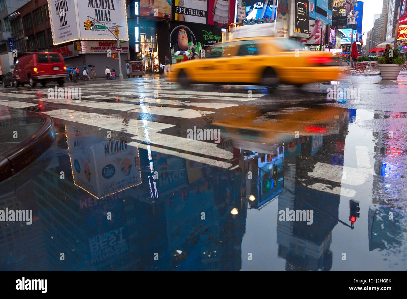Yellow cabs reflections in times square hi-res stock photography and ...