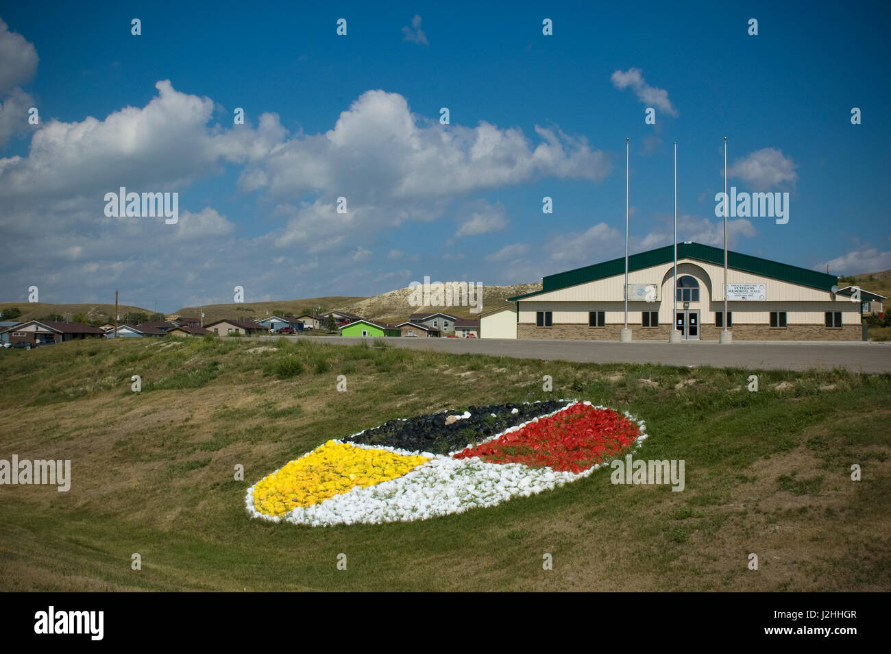 Large four color medicine wheel made with painted rocks decorates a ...