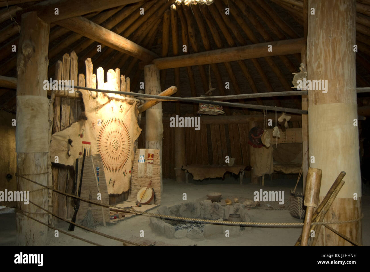 Mandan furnished earth lodge interior with fire pit on display at the ...