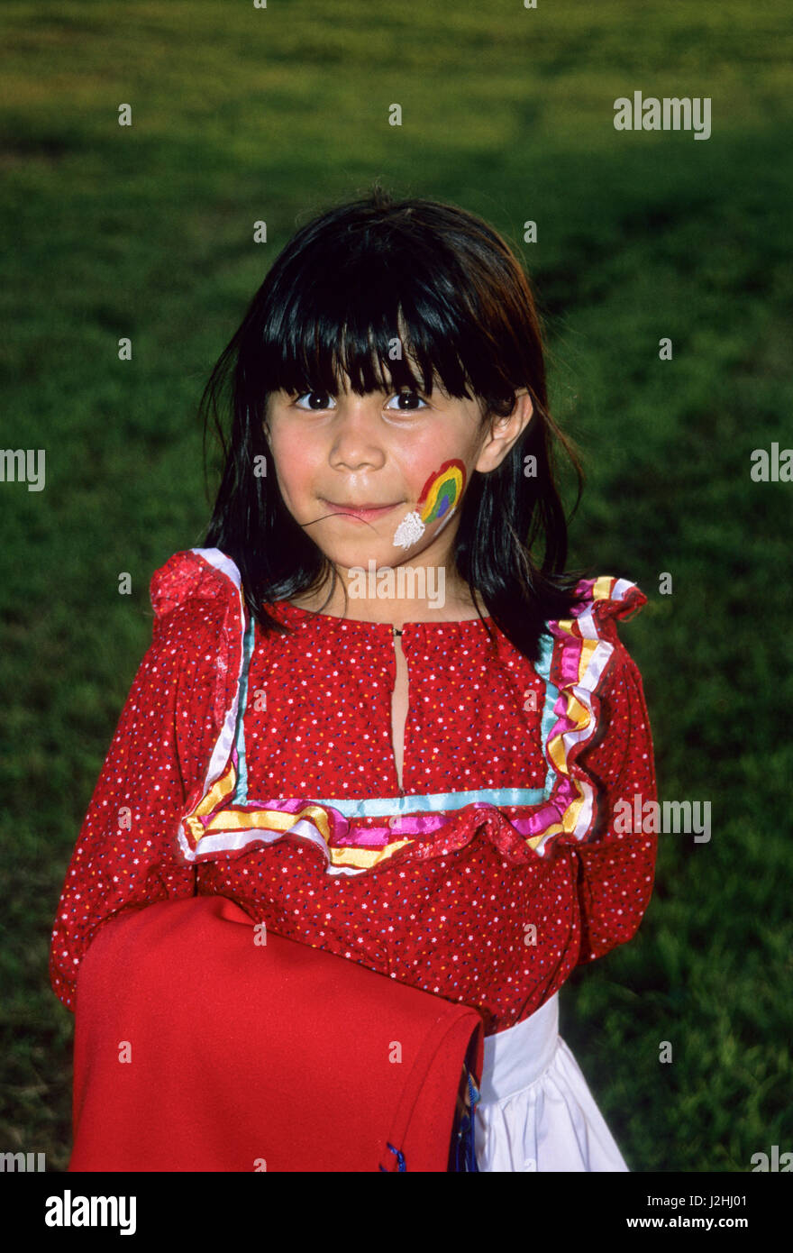 Traditional Miami girl dressed in red calico dress and shawl with a ...