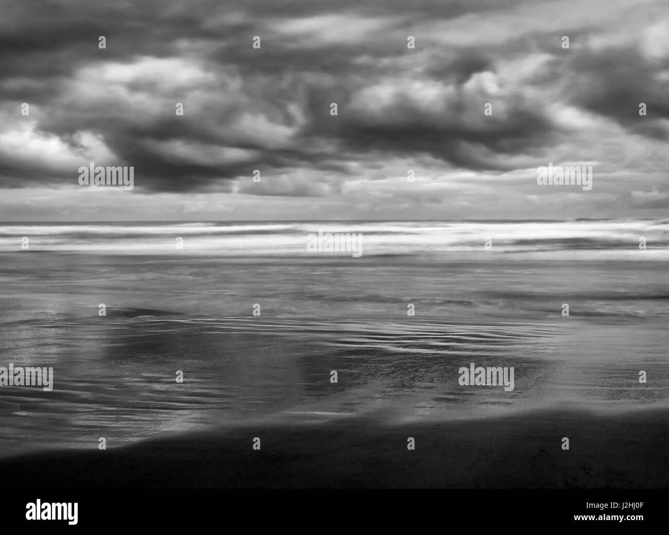 USA, Oregon, Cannon Beach, Storm clouds roil over the Pacific Ocean ...