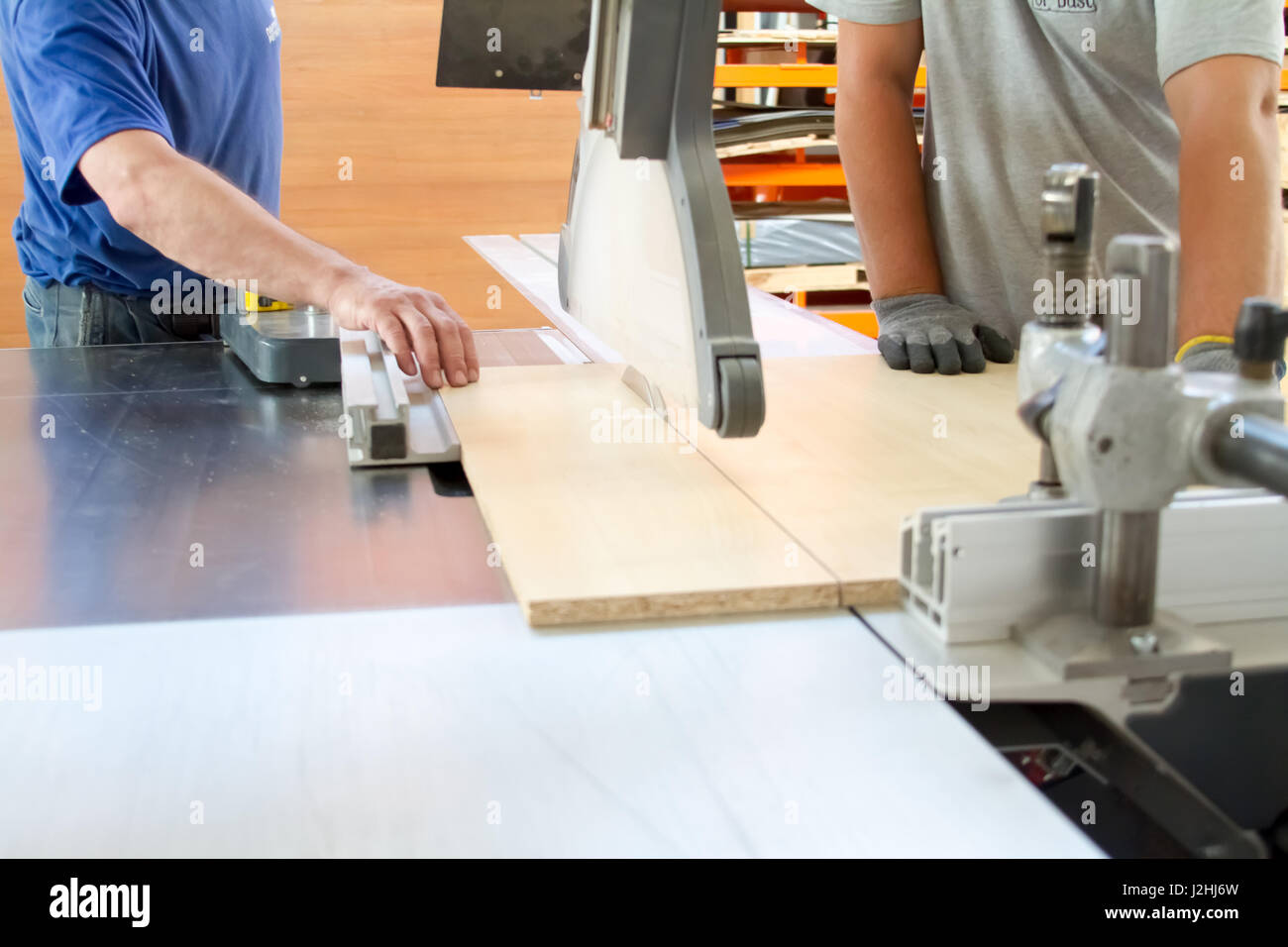 Men at work sawing wood. Circular saw. A machine which saws wood ...