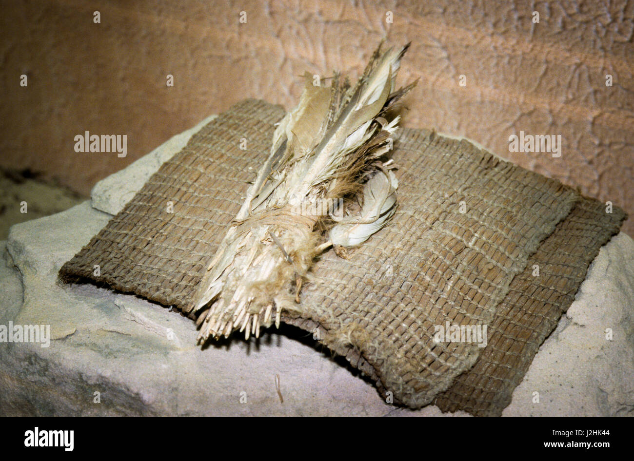 Ute ceremonial bundle of feathers lays on a woven mat made from Tule ...