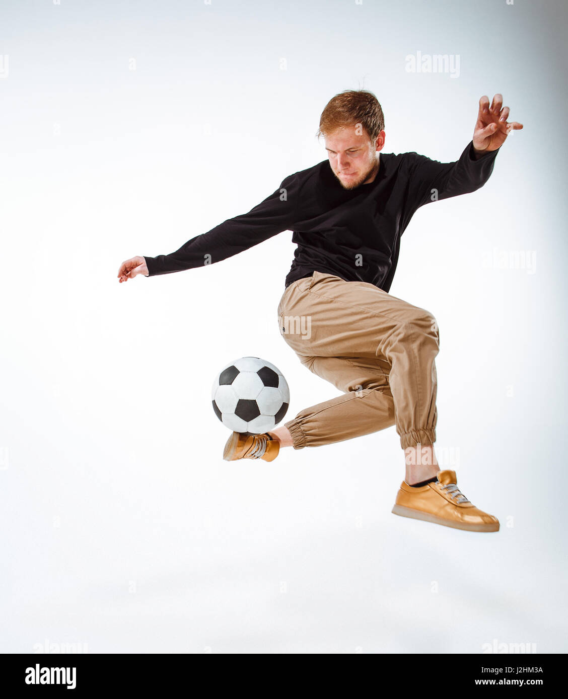 A portrait of a fan with ball on gray studio background. Freestile ...