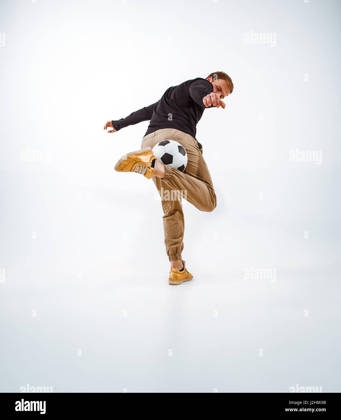 A portrait of a fan with ball on gray studio background. Freestile ...