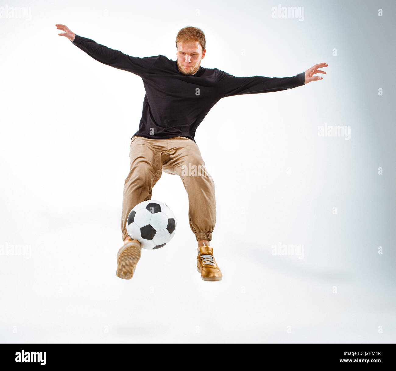 A portrait of a fan with ball on gray studio background. Freestile ...
