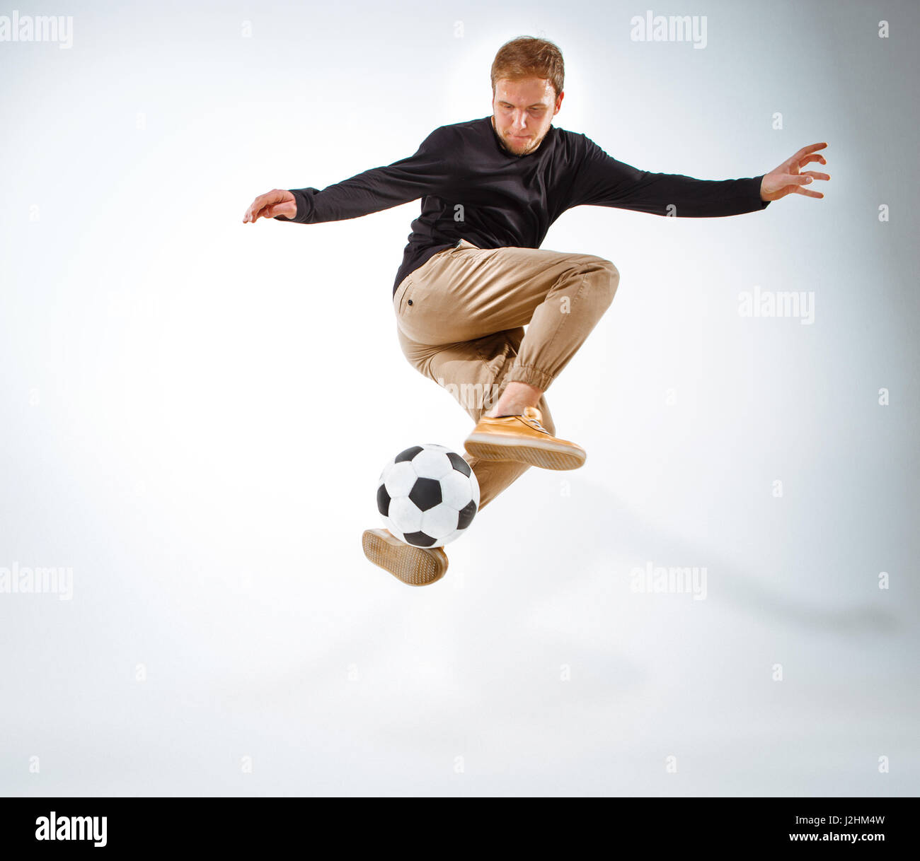 A portrait of a fan with ball on gray studio background. Freestile ...
