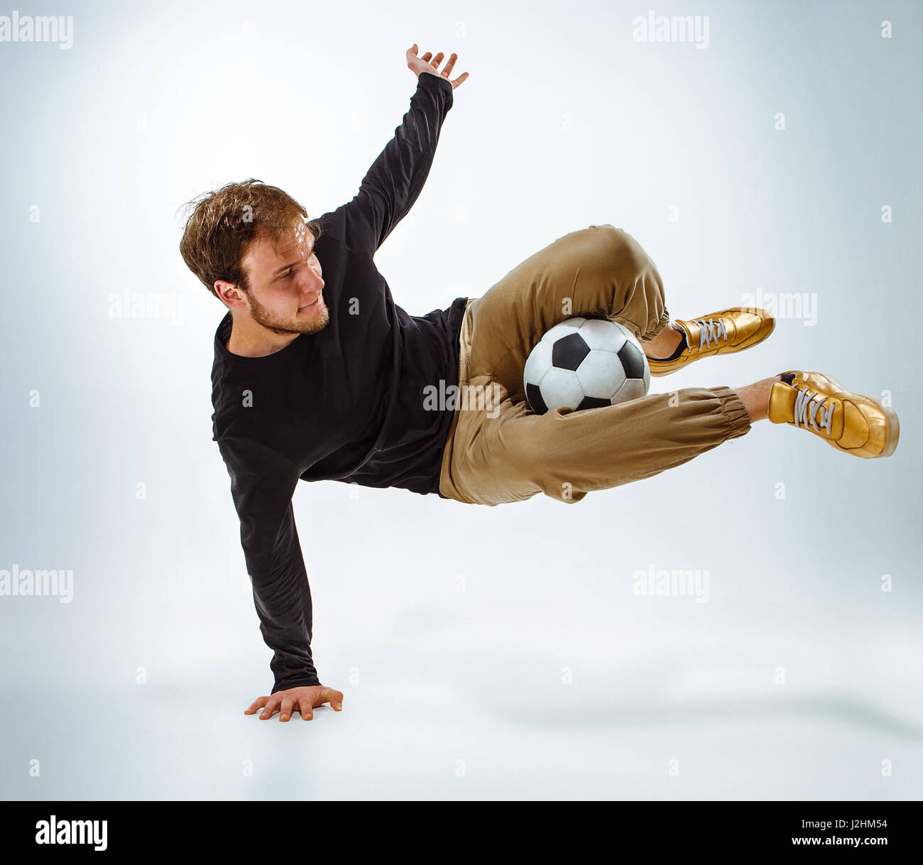 A portrait of a fan with ball on gray studio background. Freestile ...