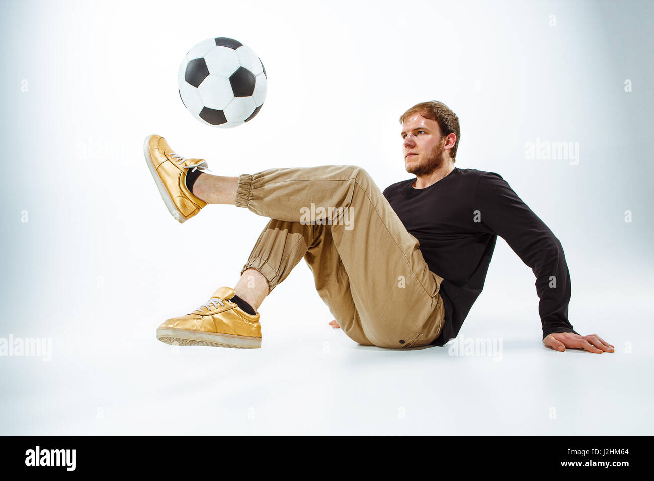 A portrait of a fan with ball on gray studio background. Freestile ...