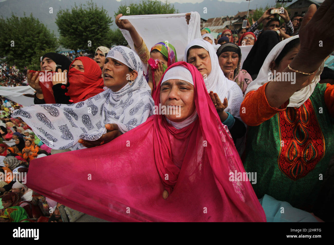 Kashmiri Woman crying during devotees pray as a head priest (not seen ...
