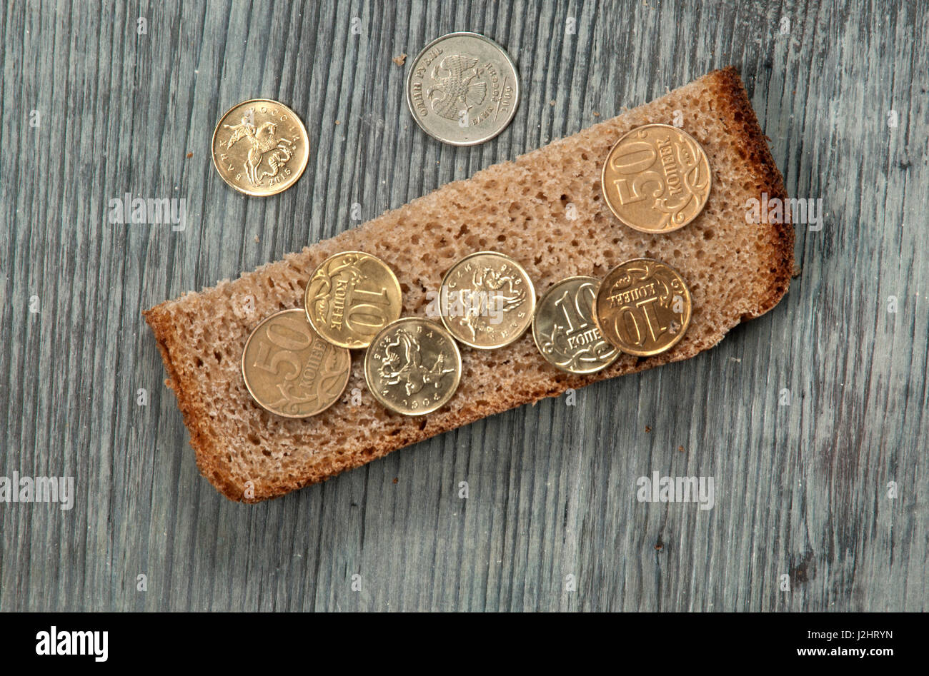 Rye bread with coins - the food of poor people concept Stock Photo - Alamy
