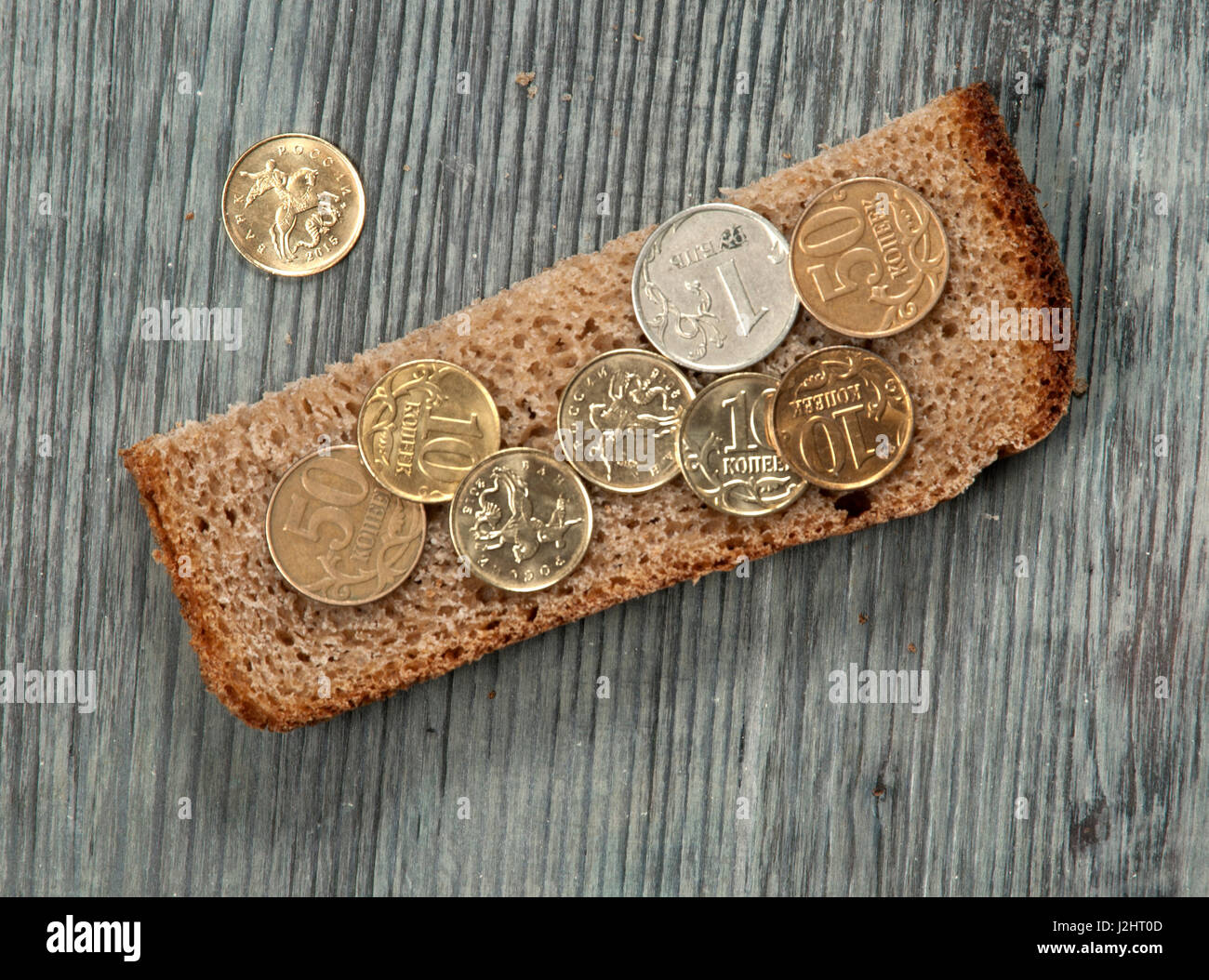Rye bread with coins - the food of poor people concept Stock Photo - Alamy