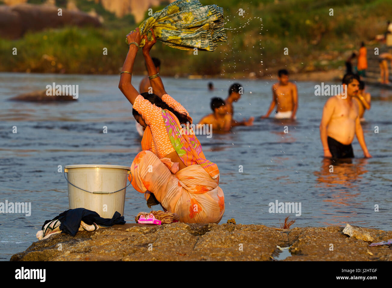 Indian woman washing clothes at Tungabhadra river, Hampi, Karnataka ...