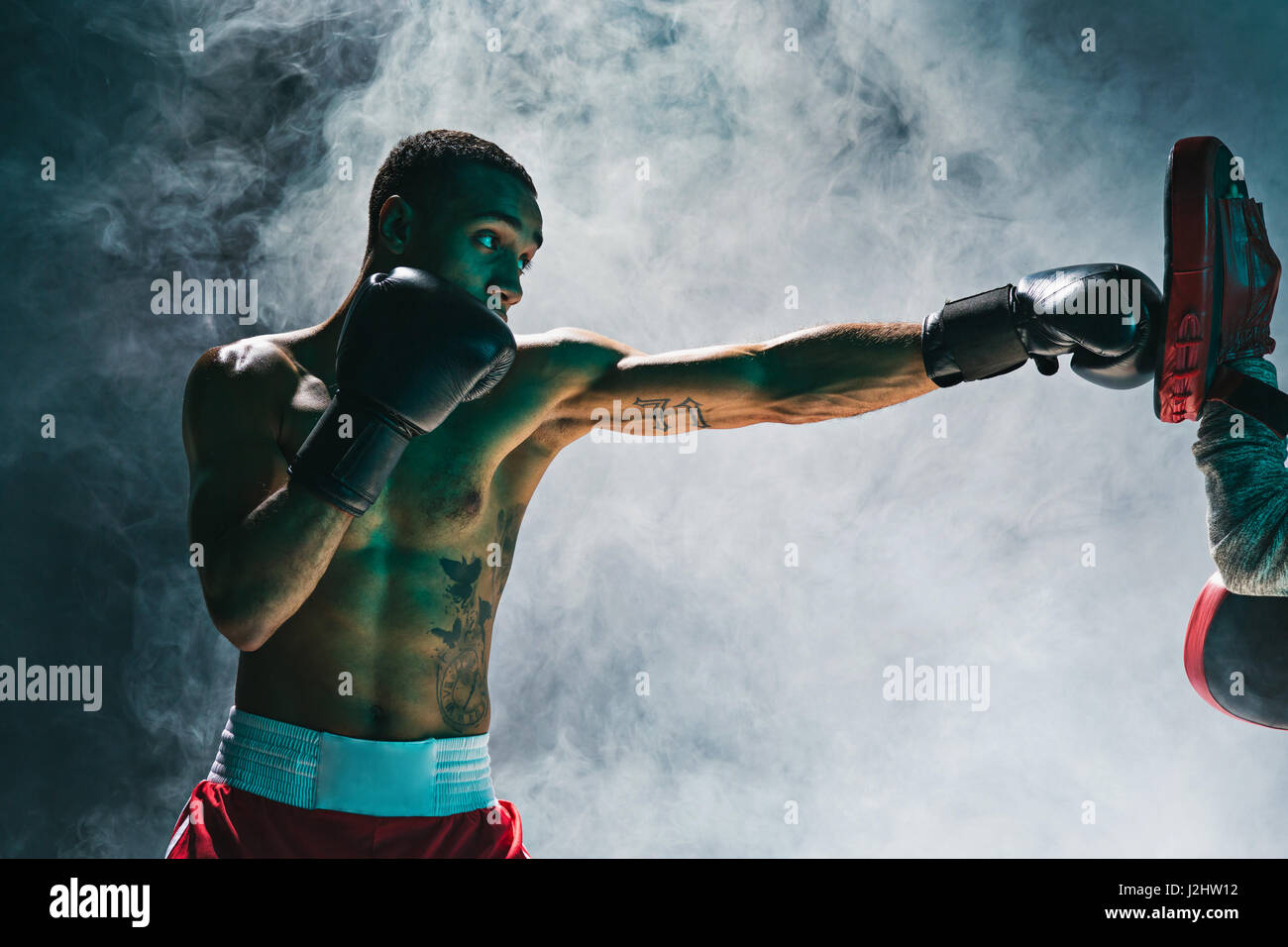 Afro american male boxer. Young man boxing workout in a fitness club ...