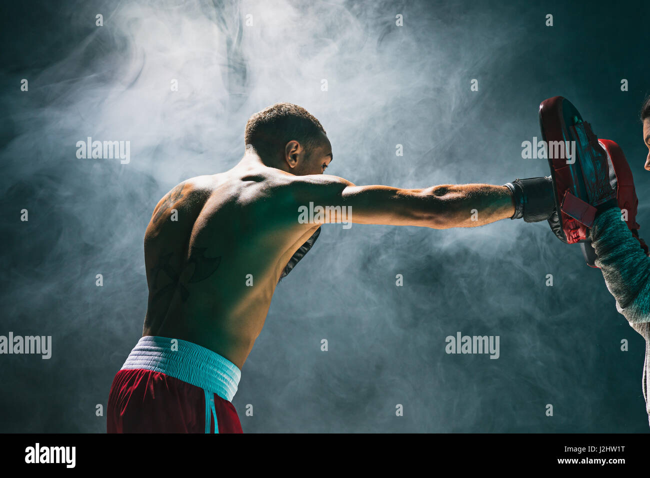 Afro american male boxer. Young man boxing workout in a fitness club ...