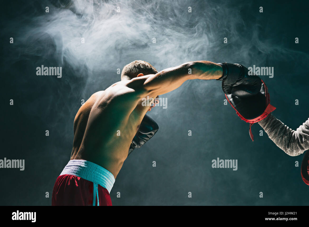 Afro american male boxer. Young man boxing workout in a fitness club ...