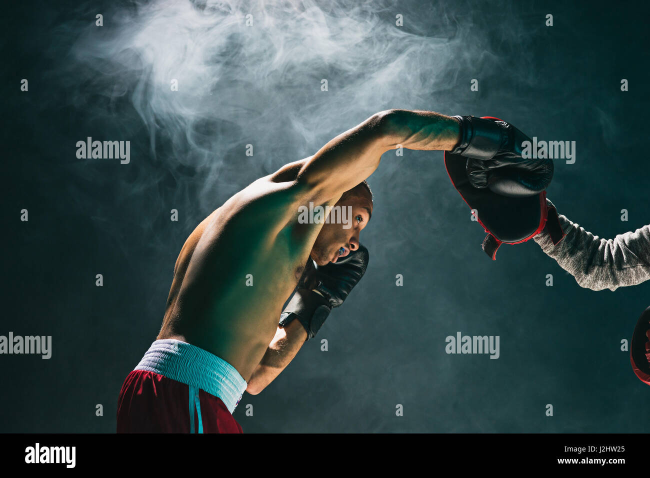 Afro american male boxer. Young man boxing workout in a fitness club ...