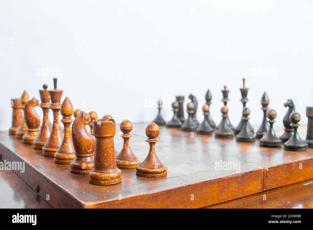 Old chess Board with wooden pieces on a white background Stock Photo ...