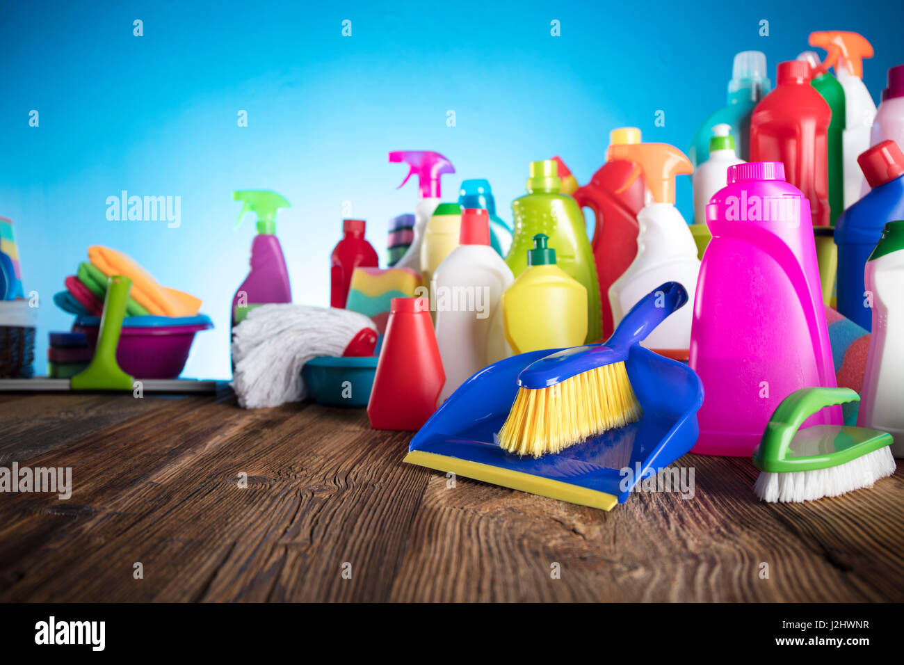Spring cleanup theme. Variety of colorful house cleaning products on a ...