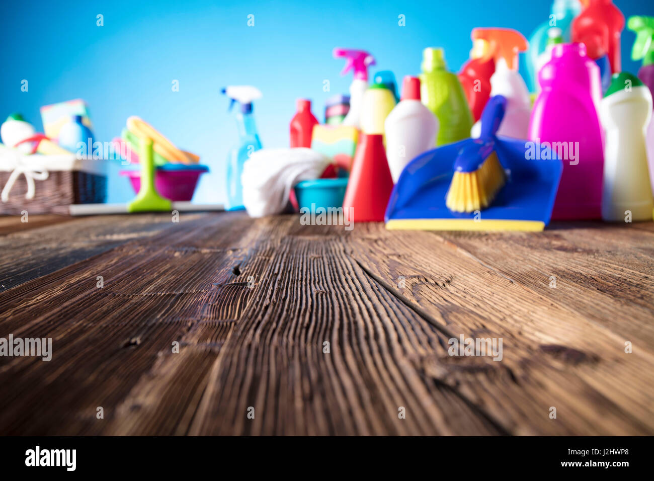Spring cleanup theme. Variety of colorful house cleaning products on a ...