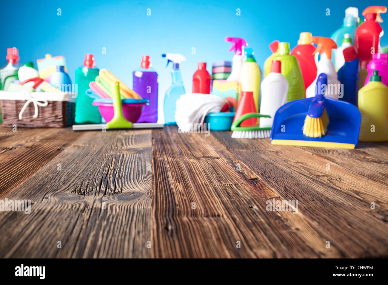 Spring cleanup theme. Variety of colorful house cleaning products on a ...
