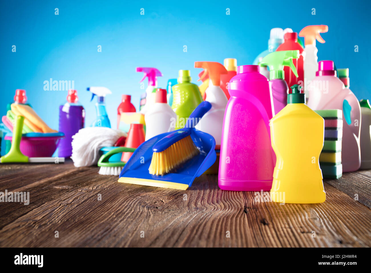Spring cleanup theme. Variety of colorful house cleaning products on a ...