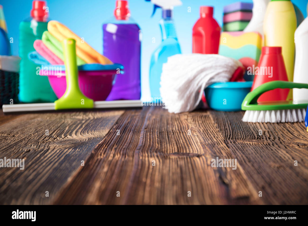 Spring cleanup theme. Variety of colorful house cleaning products on a ...
