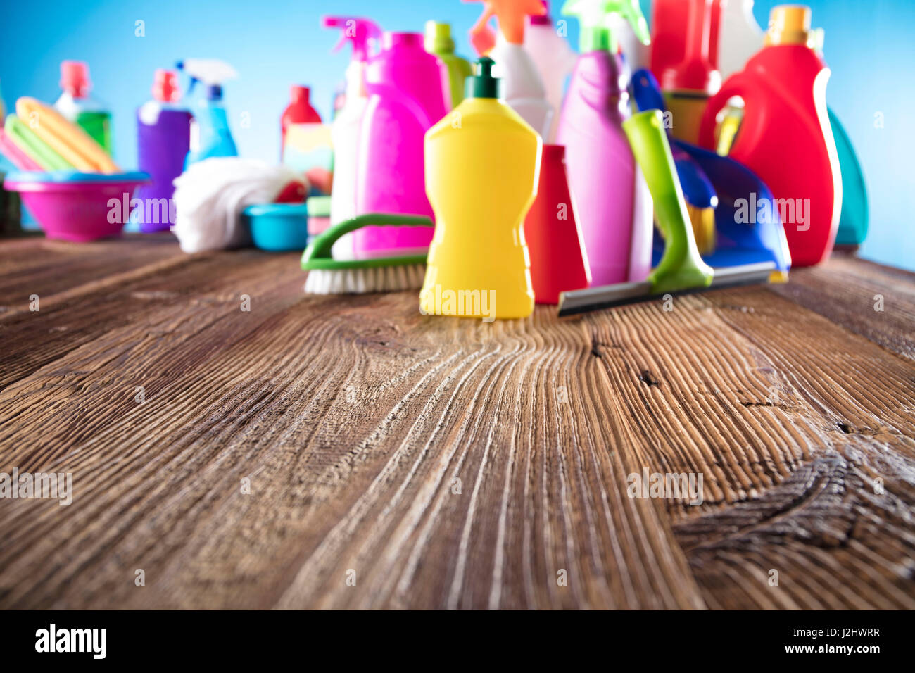 Spring cleanup theme. Variety of colorful house cleaning products on a ...
