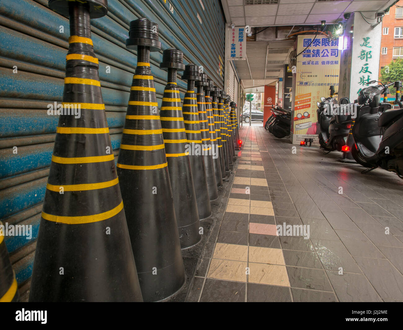 Taipei, Taiwan - October 08, 2016: Black and yellow plastic traffic ...