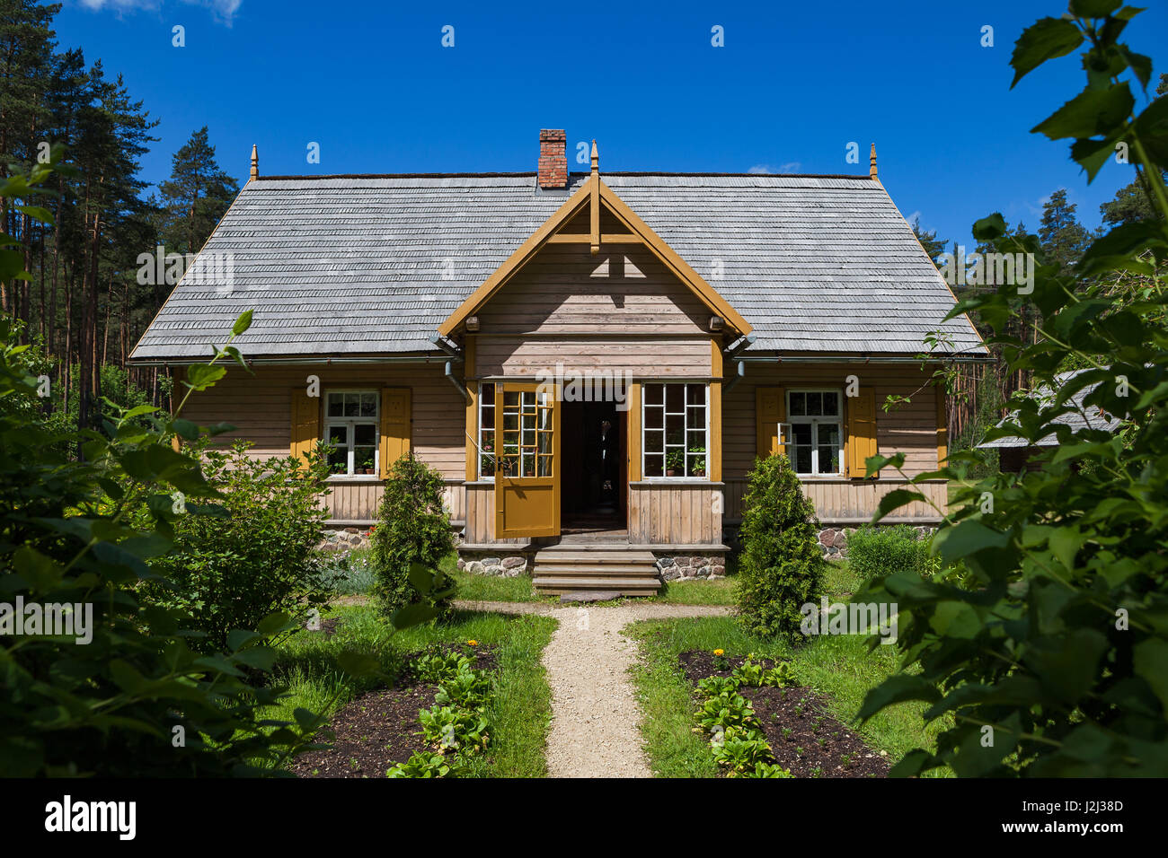 Wooden rural house and green garden, Baltic traditions, Latvia Stock ...