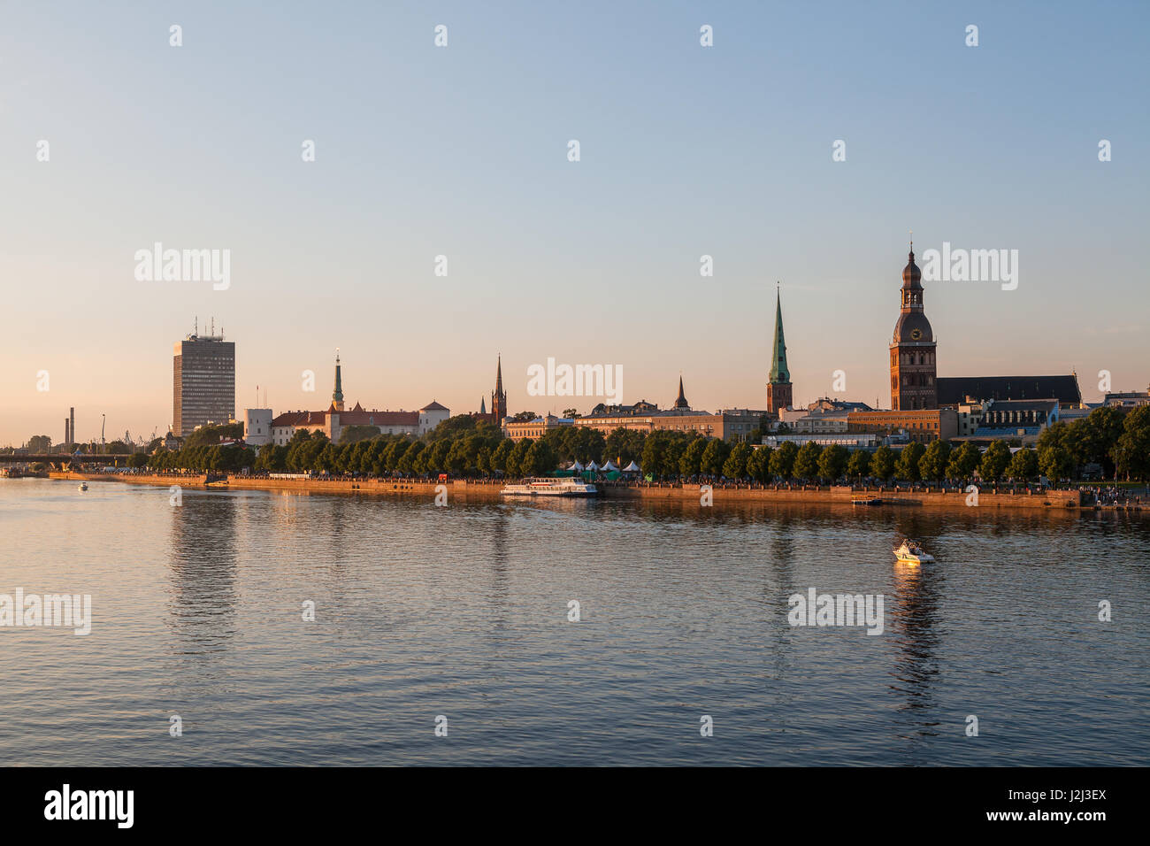 Old town of Riga summer sunset skyline with Daugava river Stock Photo ...