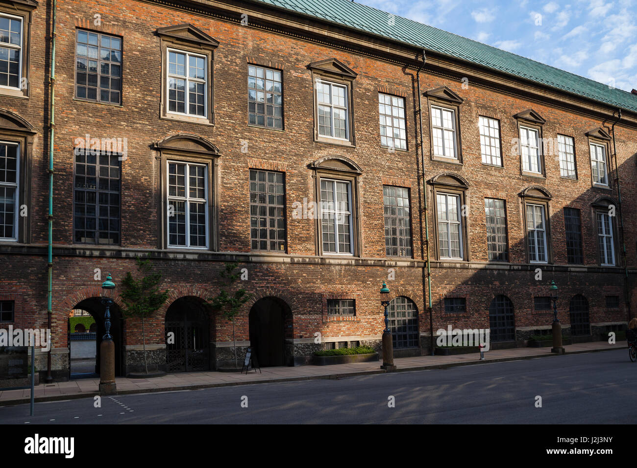 Old red brick building wall of house undera rays of sun. City center of ...