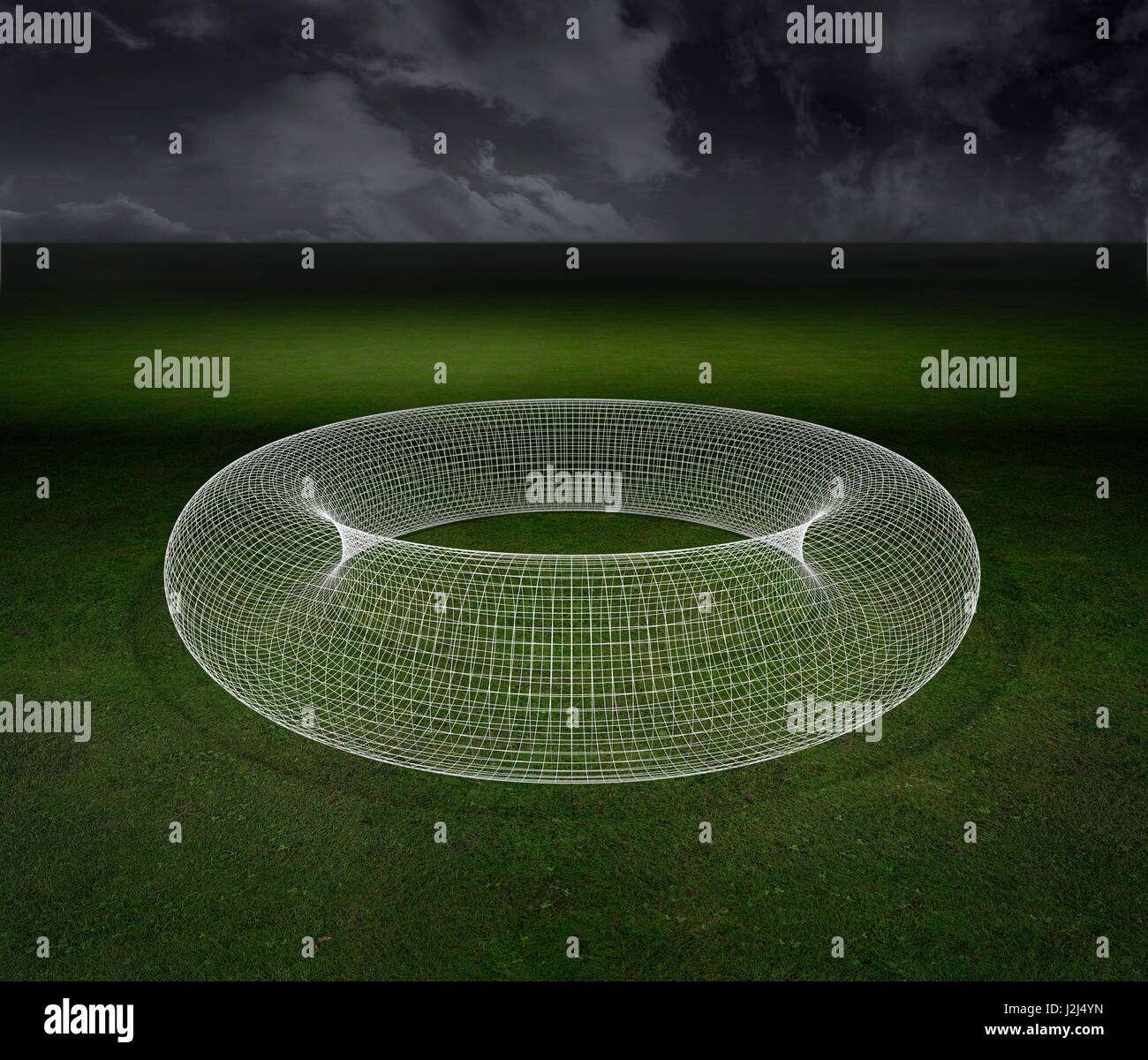 Large torus sitting on grassy plain. Computer artwork Stock Photo - Alamy