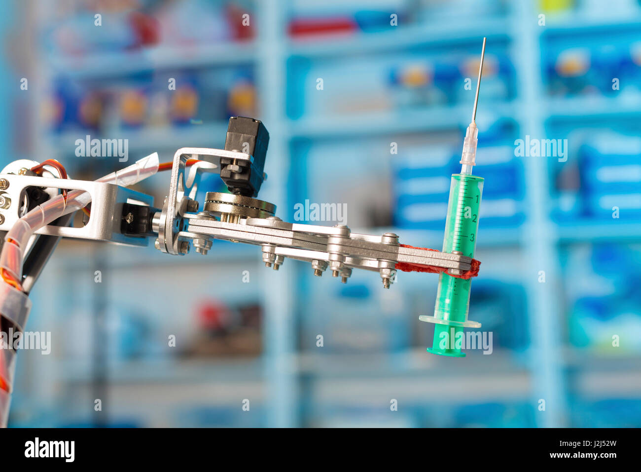 Robotic arm holding syringe in the laboratory Stock Photo - Alamy