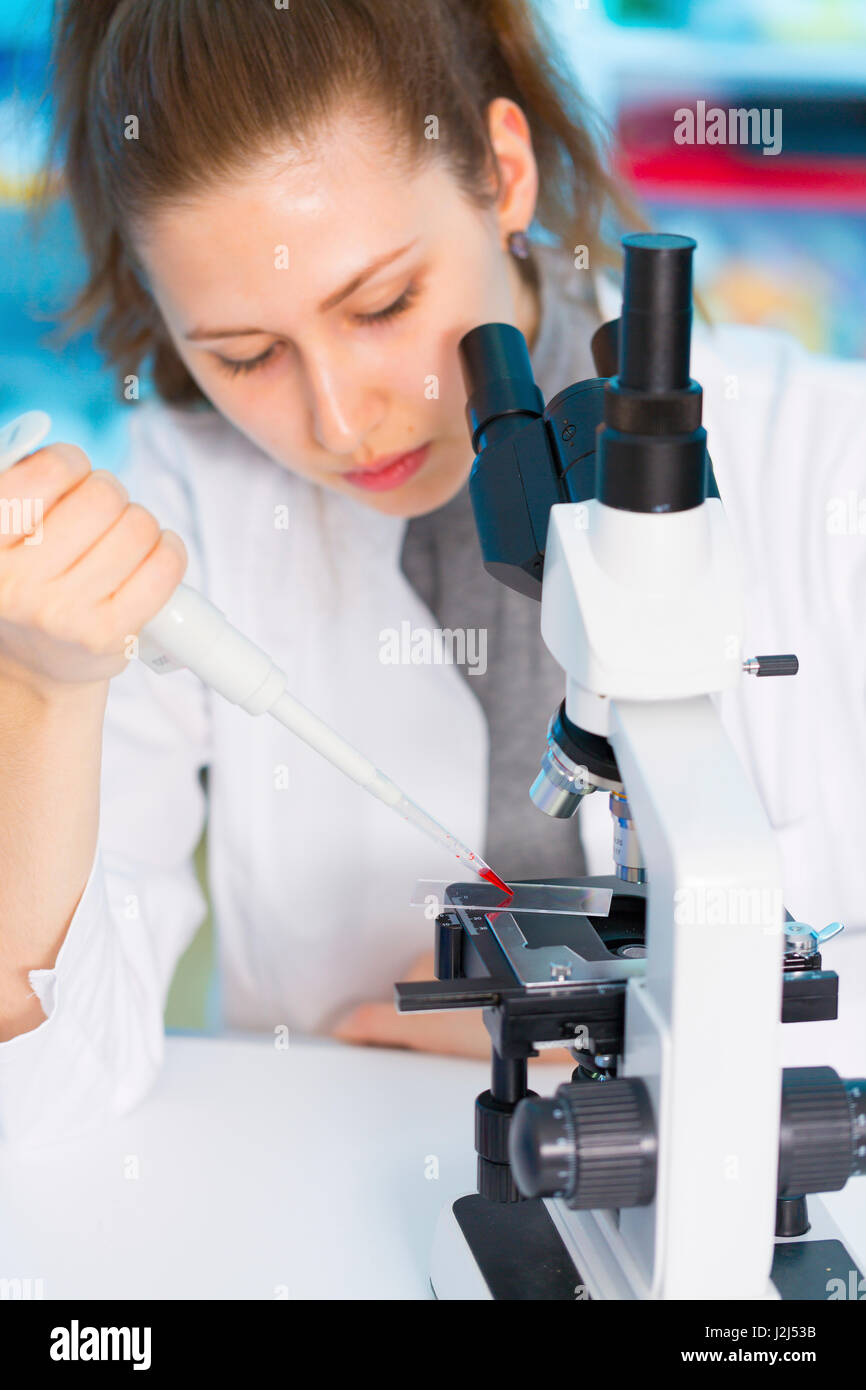 Female scientist using microscope in the laboratory Stock Photo - Alamy