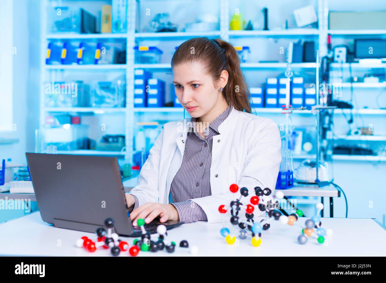 Female scientist using laptop in the laboratory Stock Photo - Alamy