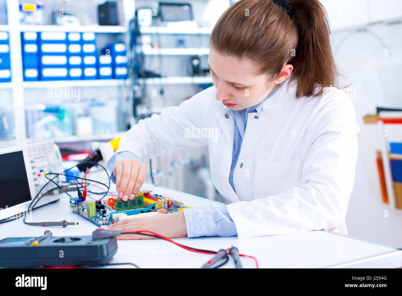 Female engineer working on a circuit board Stock Photo - Alamy