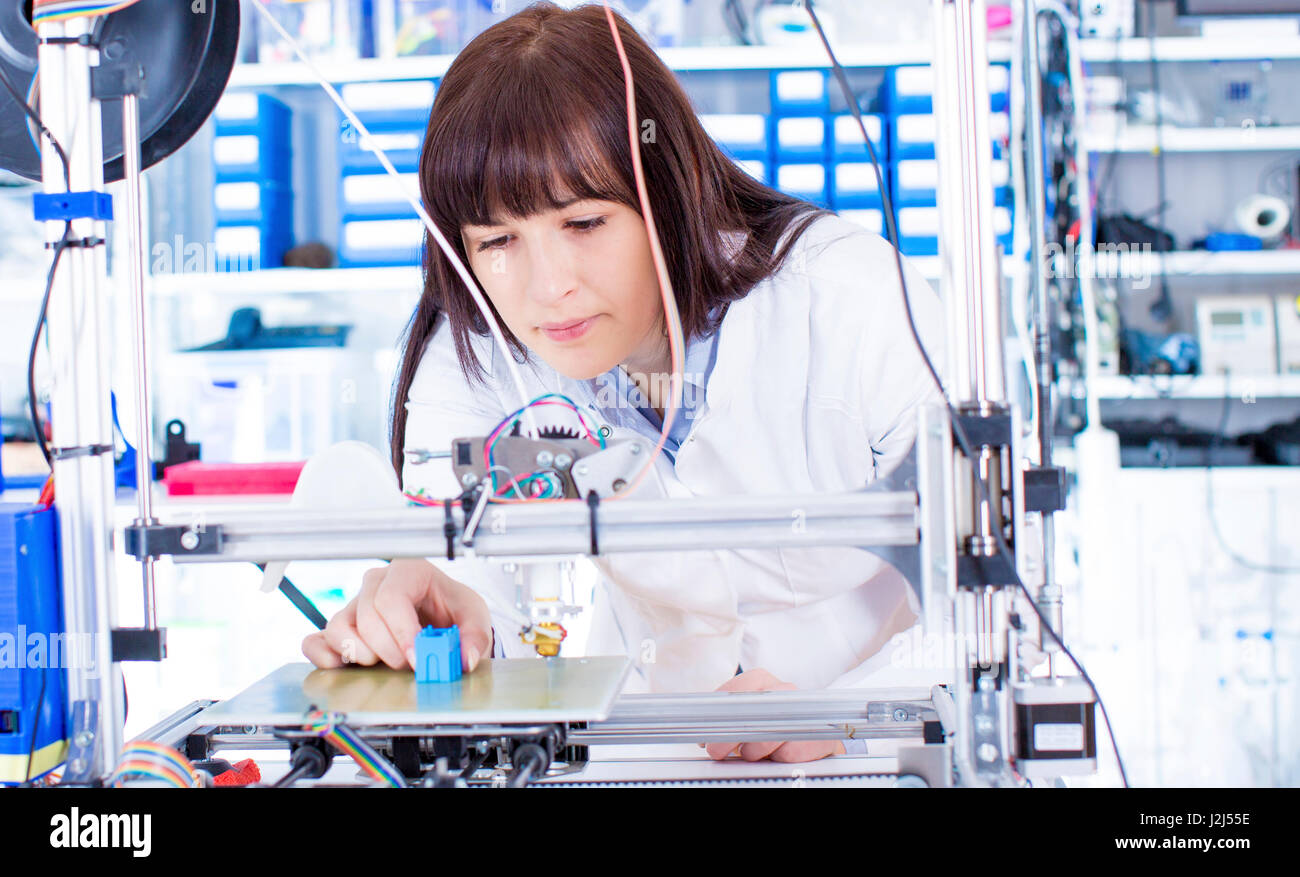 Female electronics student working in robotics laboratory Stock Photo ...