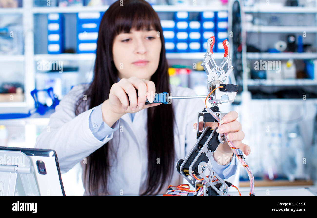 Female electronics student working in robotics laboratory Stock Photo ...