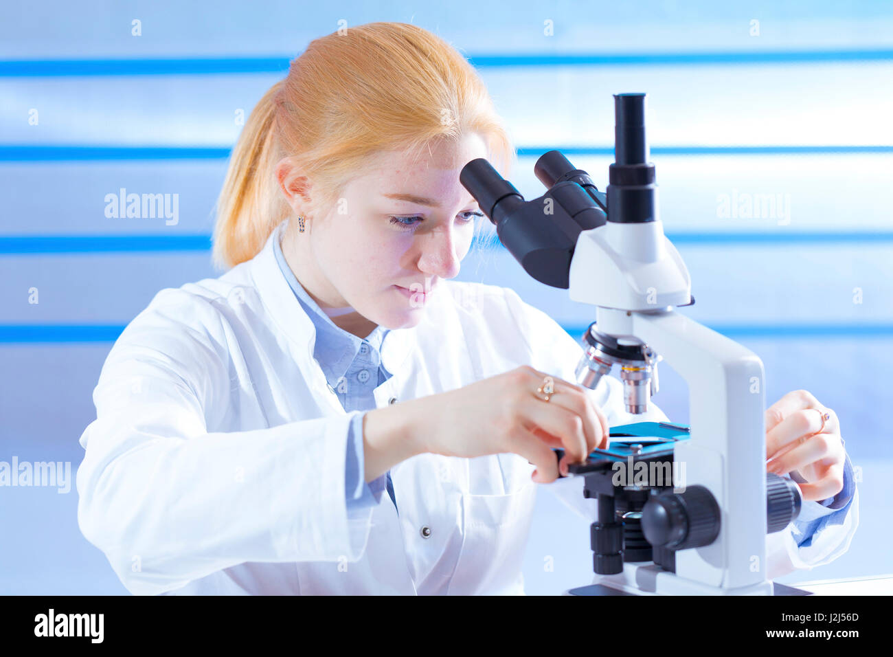 Female scientist using microscope Stock Photo - Alamy