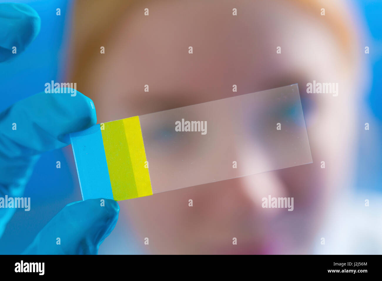Female scientist examining microscope slide Stock Photo - Alamy