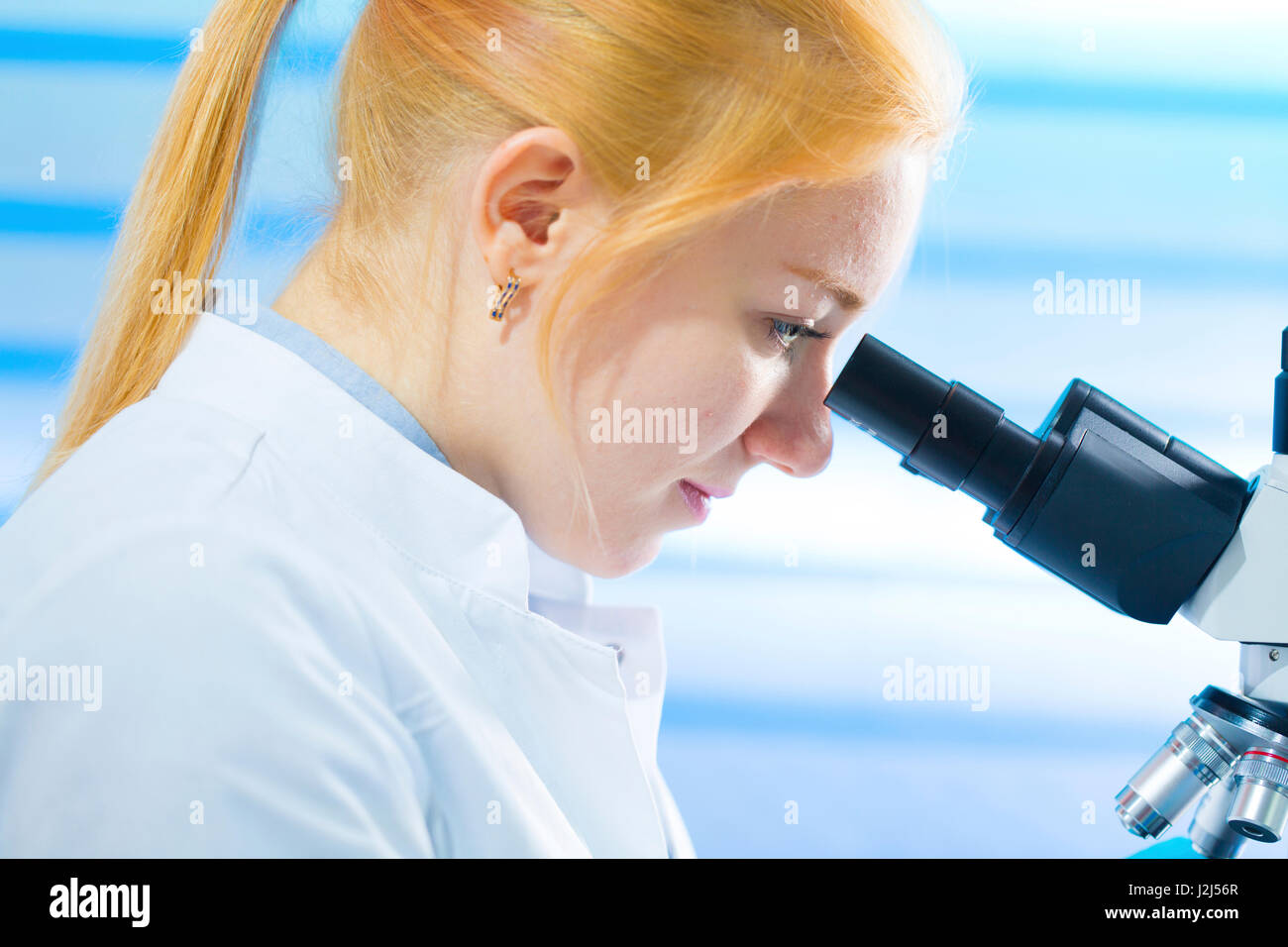 Female scientist using microscope Stock Photo - Alamy