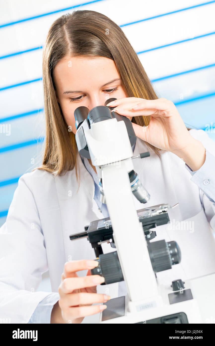 Female scientist using microscope Stock Photo - Alamy