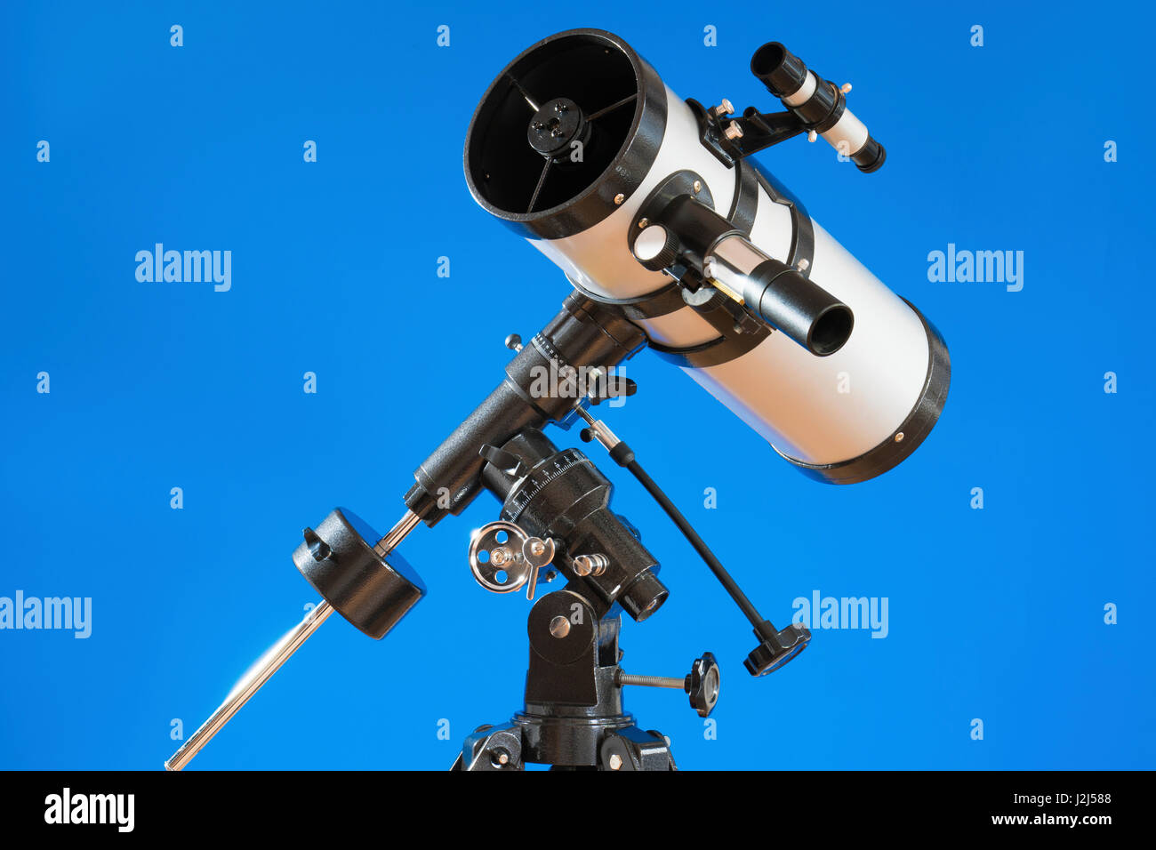 Telescope against blue background Stock Photo - Alamy