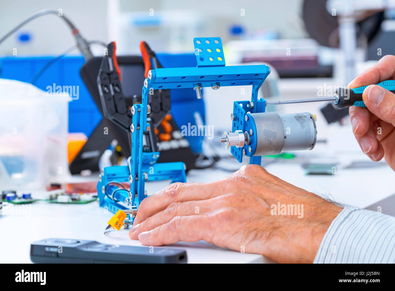 Person working with robotic parts Stock Photo - Alamy