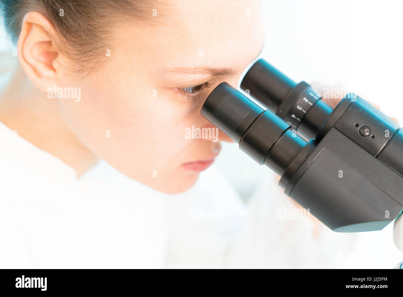 Female scientist using microscope Stock Photo - Alamy