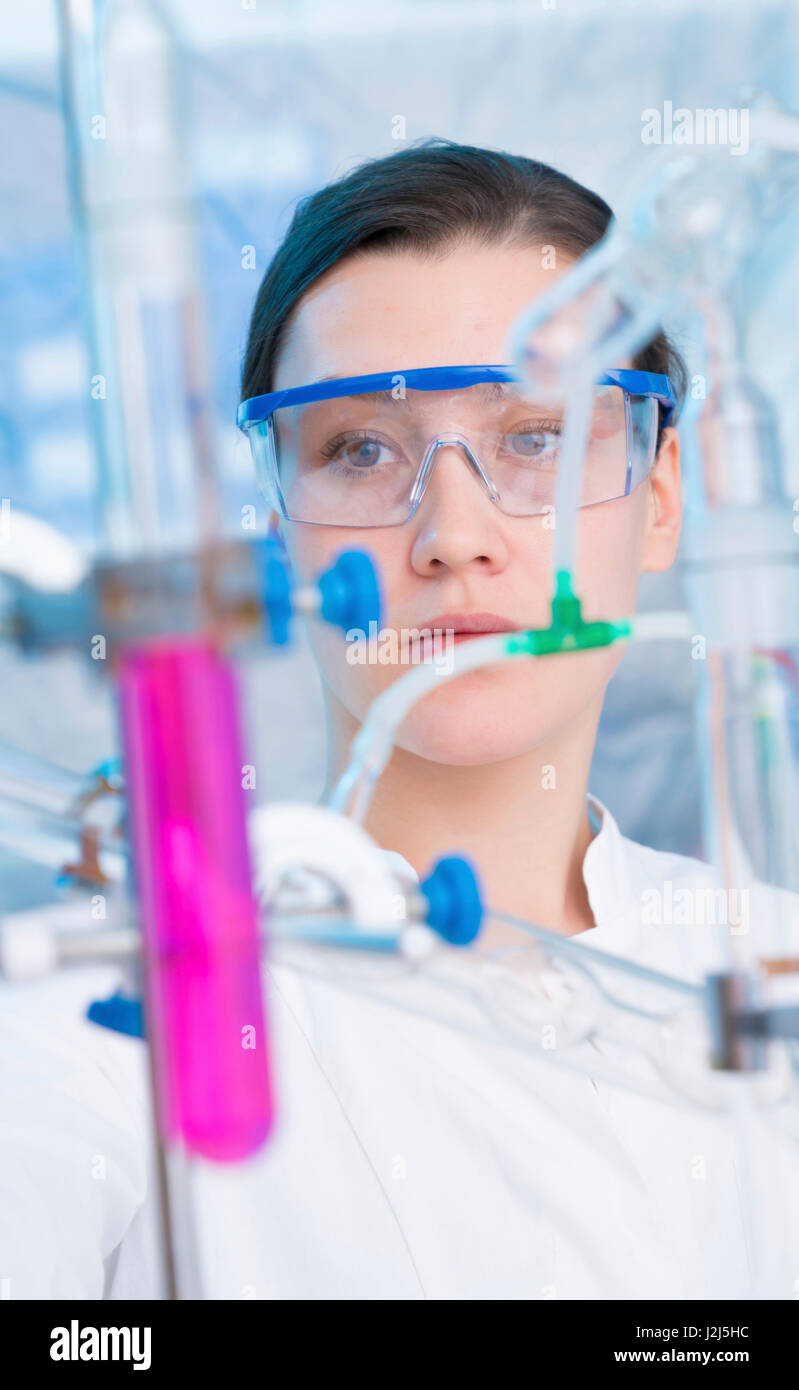 Female scientist doing experiment Stock Photo - Alamy