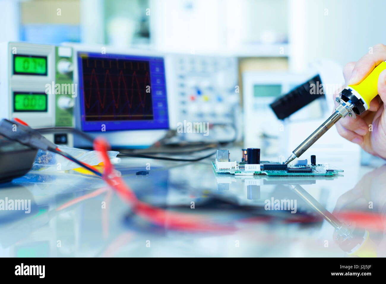 Person working in an electronics laboratory Stock Photo - Alamy