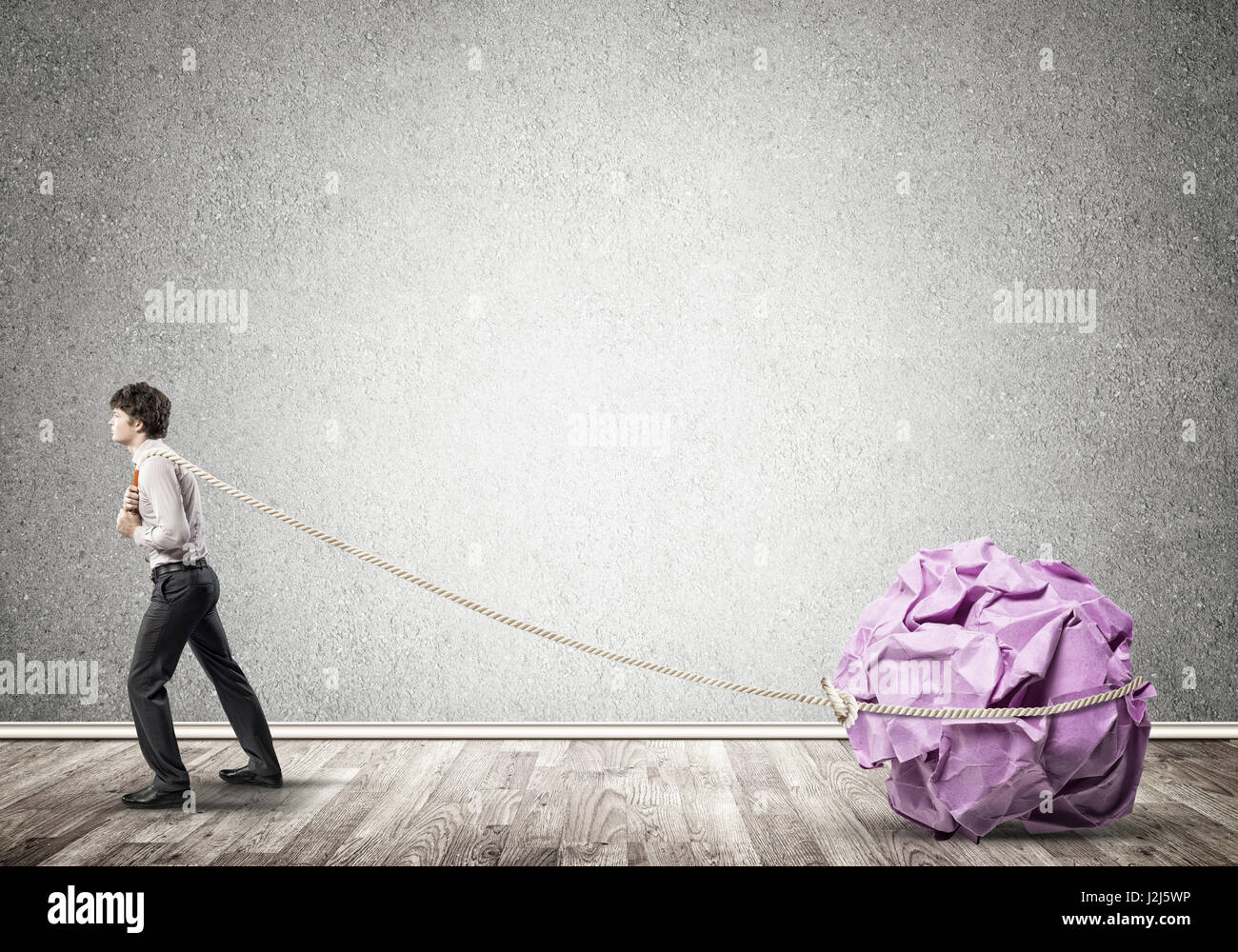 Man pulling big crumpled ball hi-res stock photography and images - Alamy